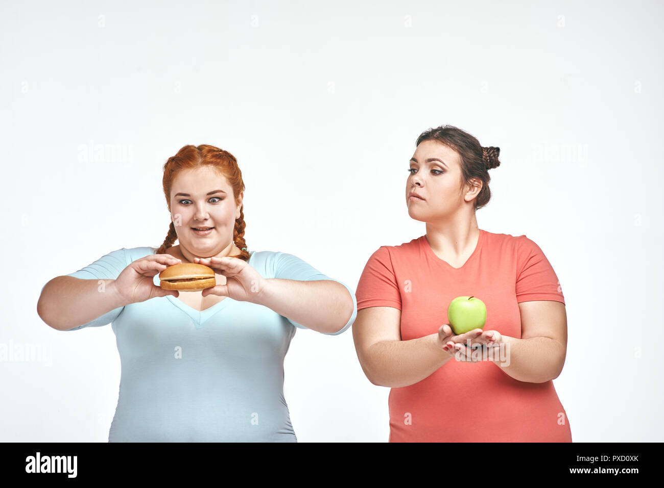 Chubby women: one woman is holding a sandwich,another one holding an ...