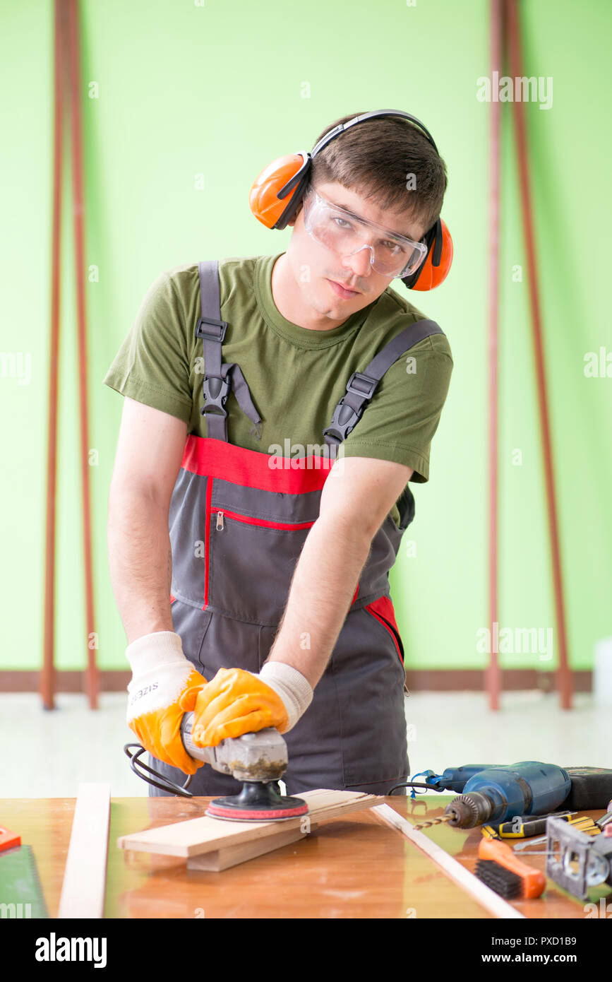 Young man carpenter working in workshop Stock Photo - Alamy