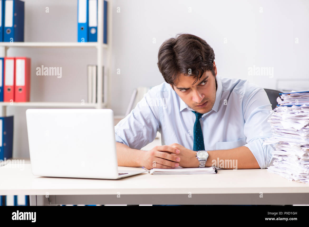 Overloaded busy employee with too much work and paperwork Stock Photo ...
