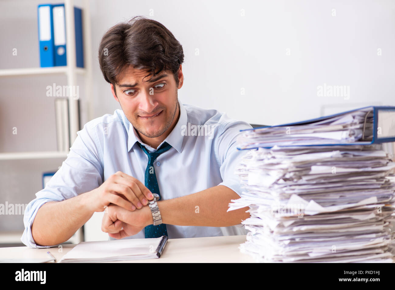 Overloaded busy employee with too much work and paperwork Stock Photo ...