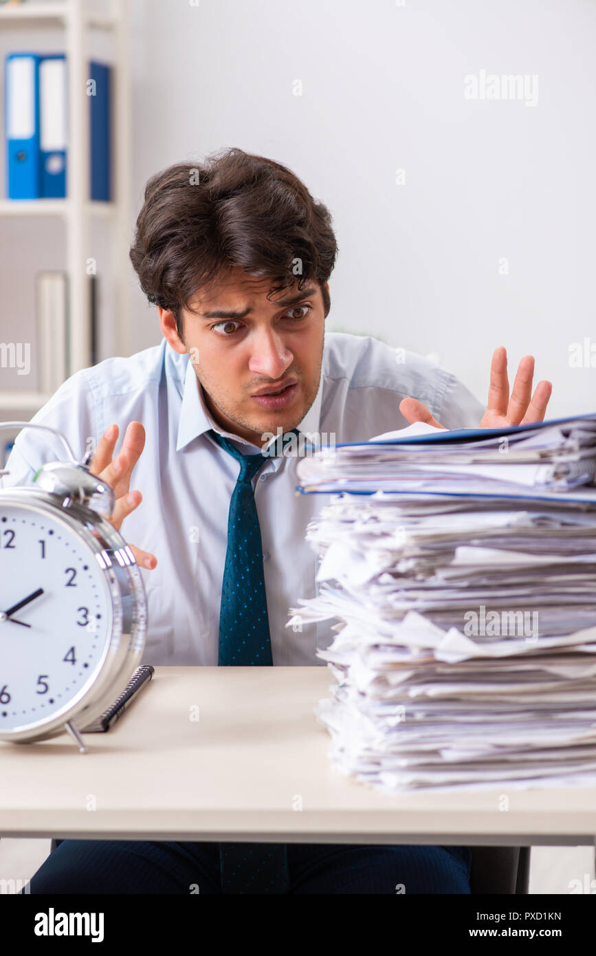Overloaded busy employee with too much work and paperwork Stock Photo ...