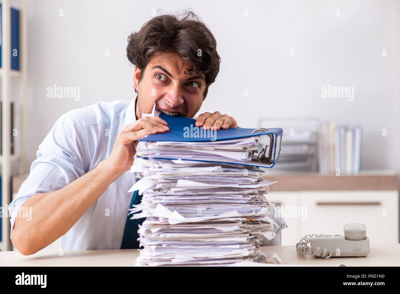 Overloaded busy employee with too much work and paperwork Stock Photo ...