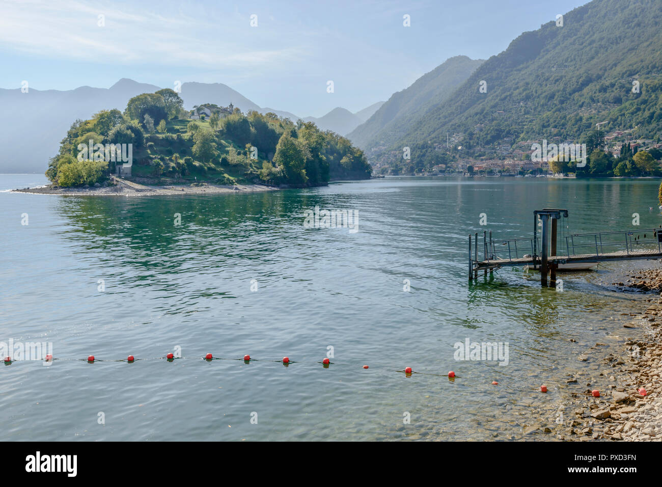 landscape of green Como lake with landing in front of Comacina island ...