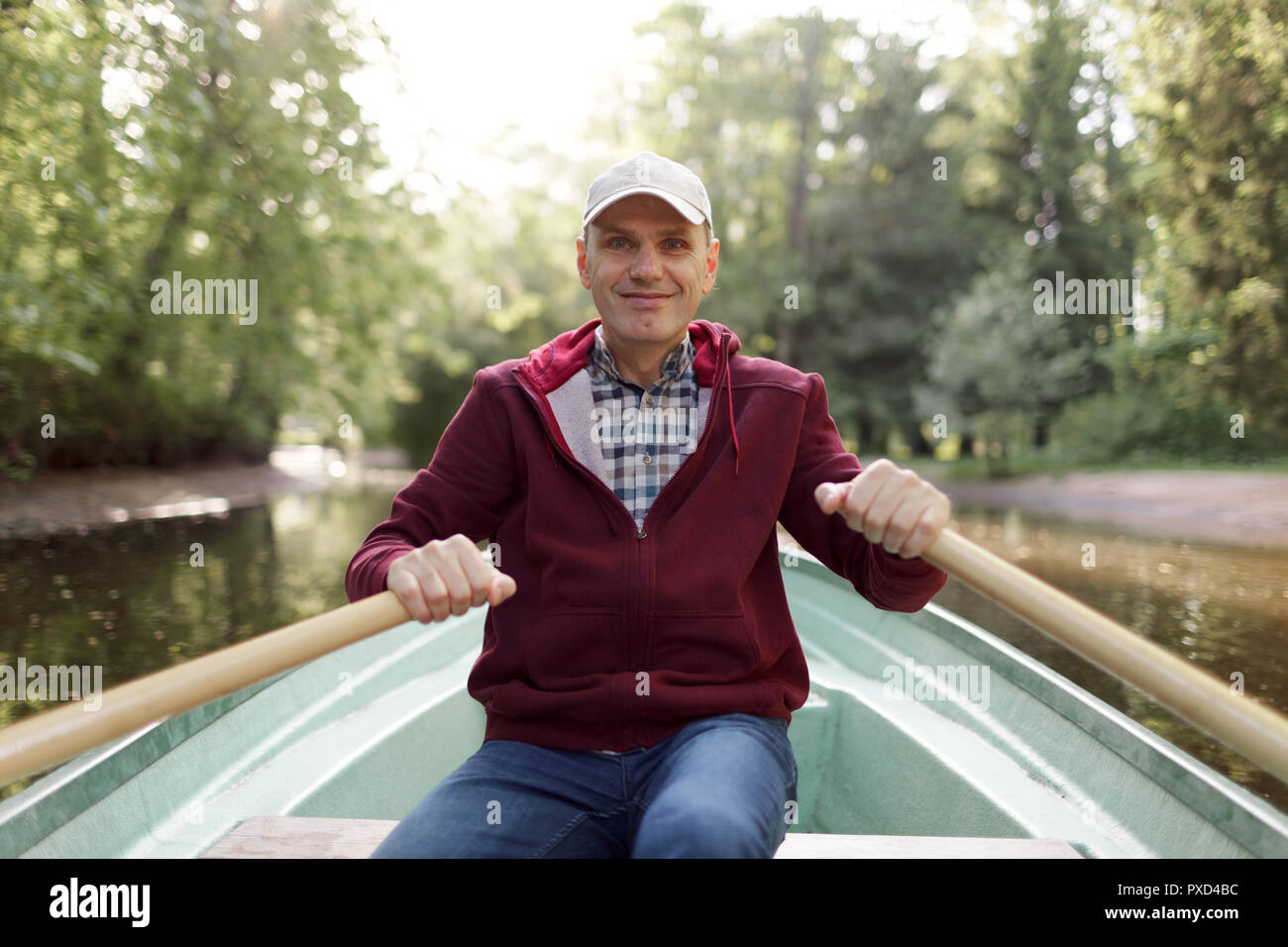 Man rowing rowboat on lake hi-res stock photography and images - Alamy