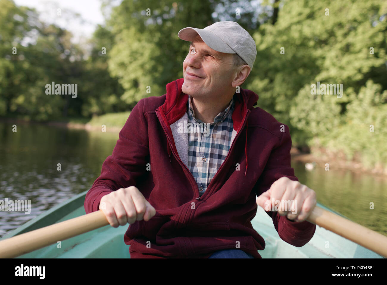 Man rowing rowboat on lake hi-res stock photography and images - Alamy