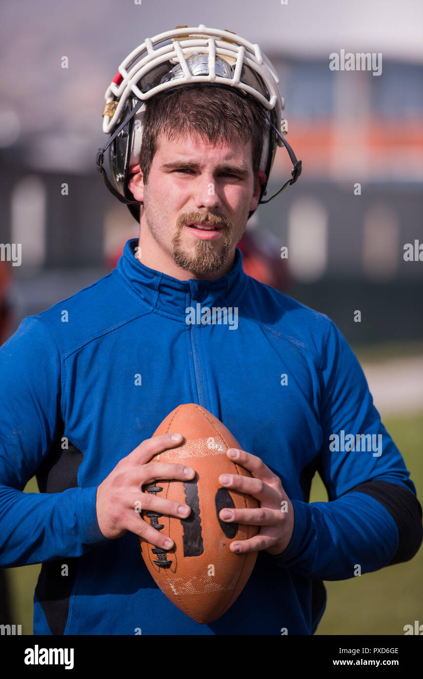 portrait of young confident American football player standing on a ...