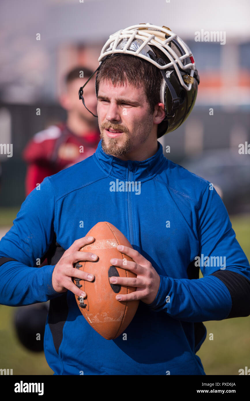 portrait of young confident American football player standing on a ...