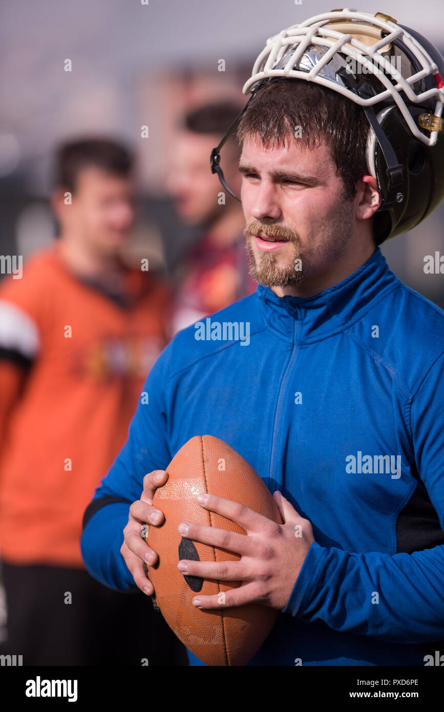portrait of young confident American football player standing on a ...