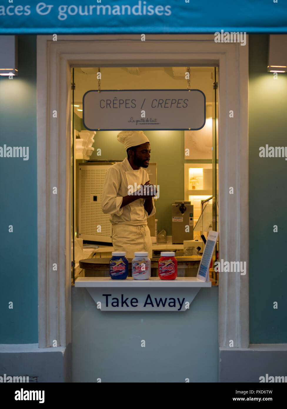 Paris, France - August 12, 2018 : Chef at take away counter serving ...