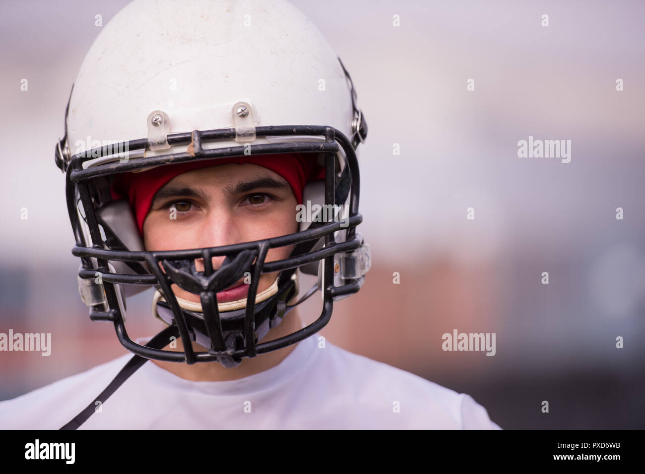 portrait of young confident American football player standing on a ...