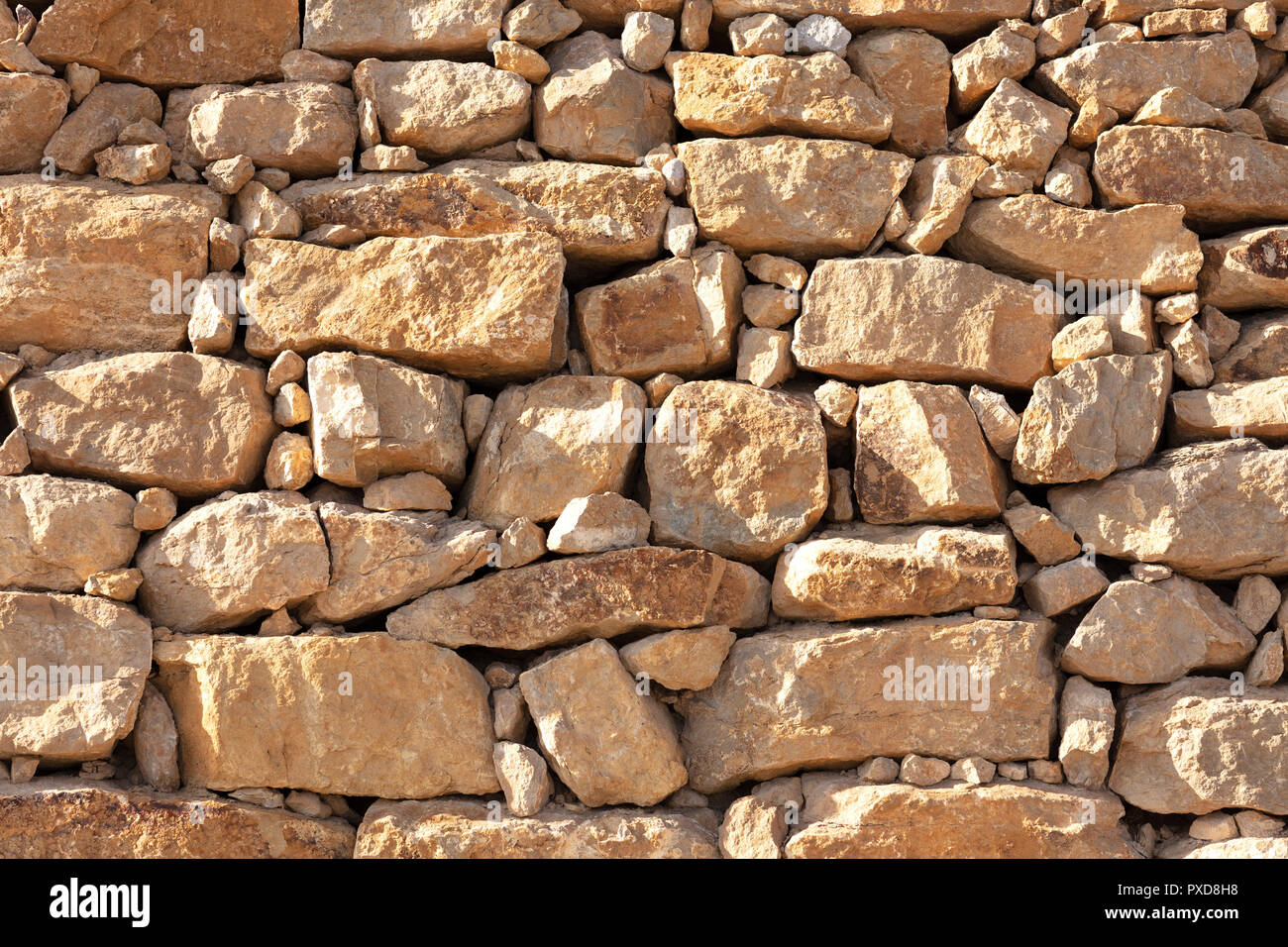 wall of yellow irregular stone blocks with various sizes Stock Photo ...