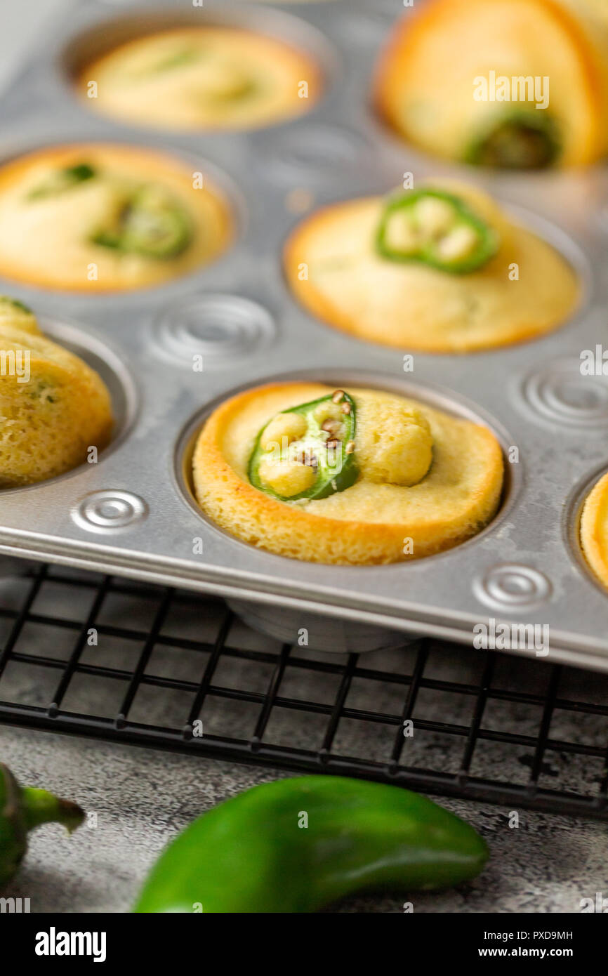Freshly baked cornbread muffins with spicy jalapeno pepper in muffin ...