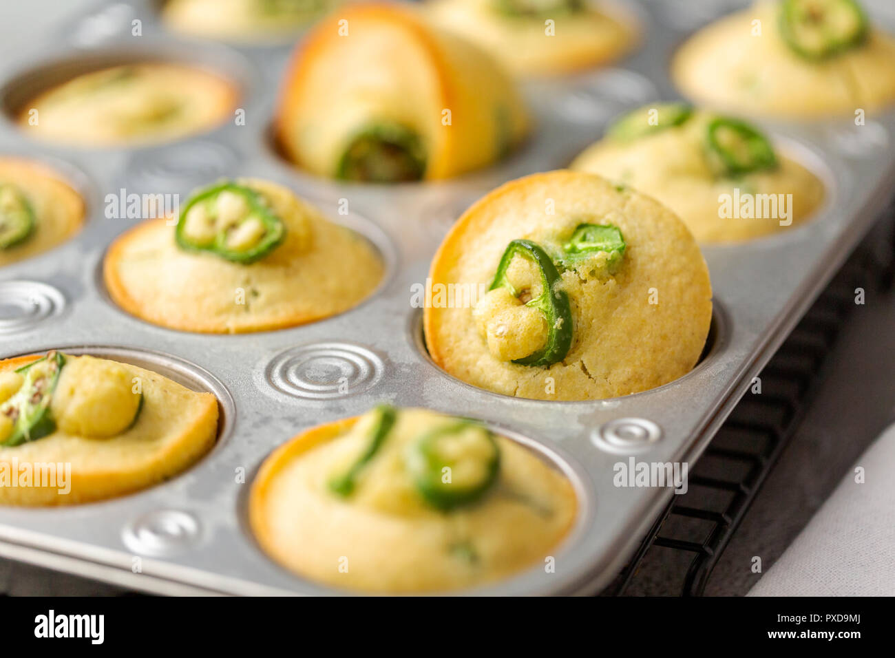 Freshly baked cornbread muffins with spicy jalapeno pepper in muffin ...