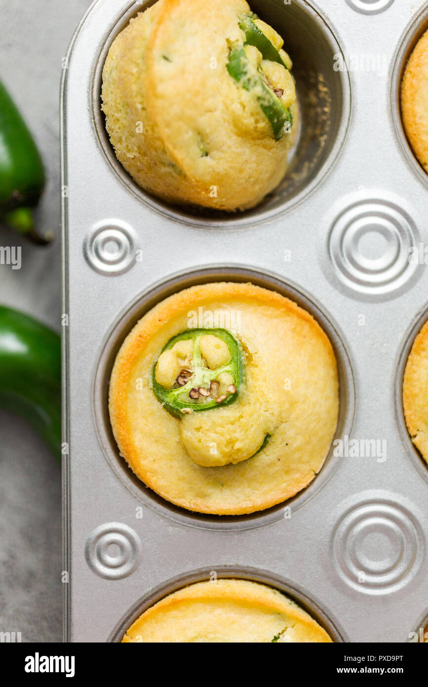 Flat lay. Freshly baked cornbread muffins with spicy jalapeno pepper in ...