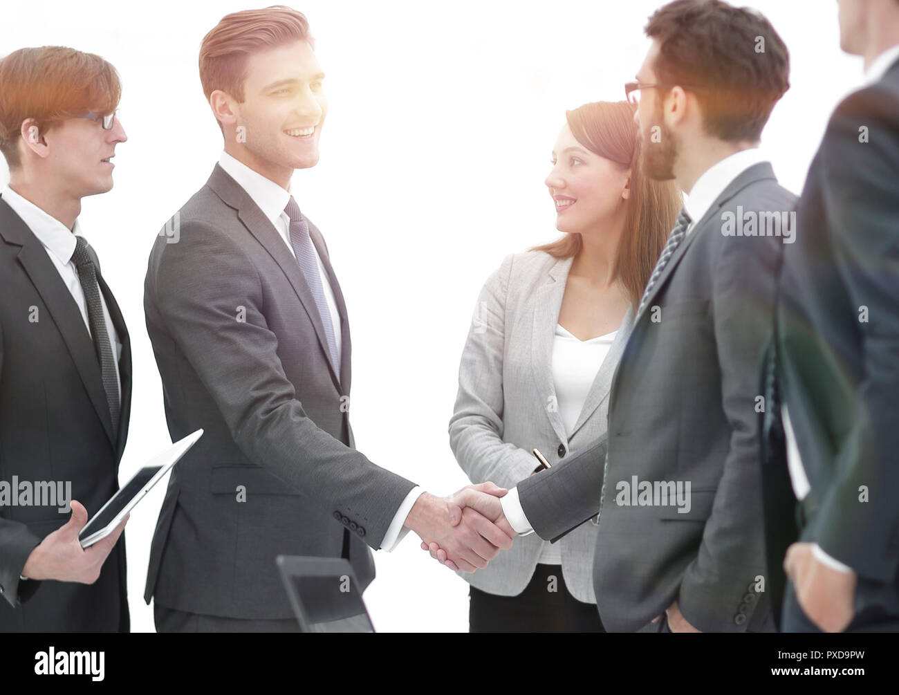 Business partners handshaking with their colleagues Stock Photo - Alamy