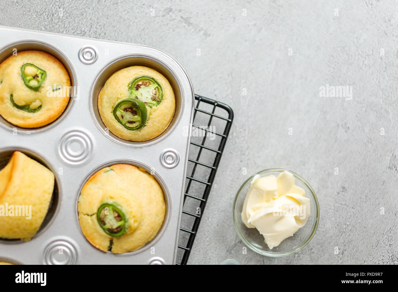 Flat lay. Freshly baked cornbread muffins with spicy jalapeno pepper in ...