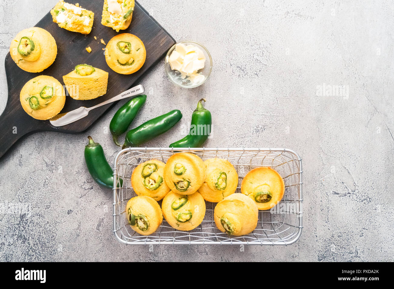 Flat lay. Freshly baked cornbread muffins with spicy jalapeno pepper in ...