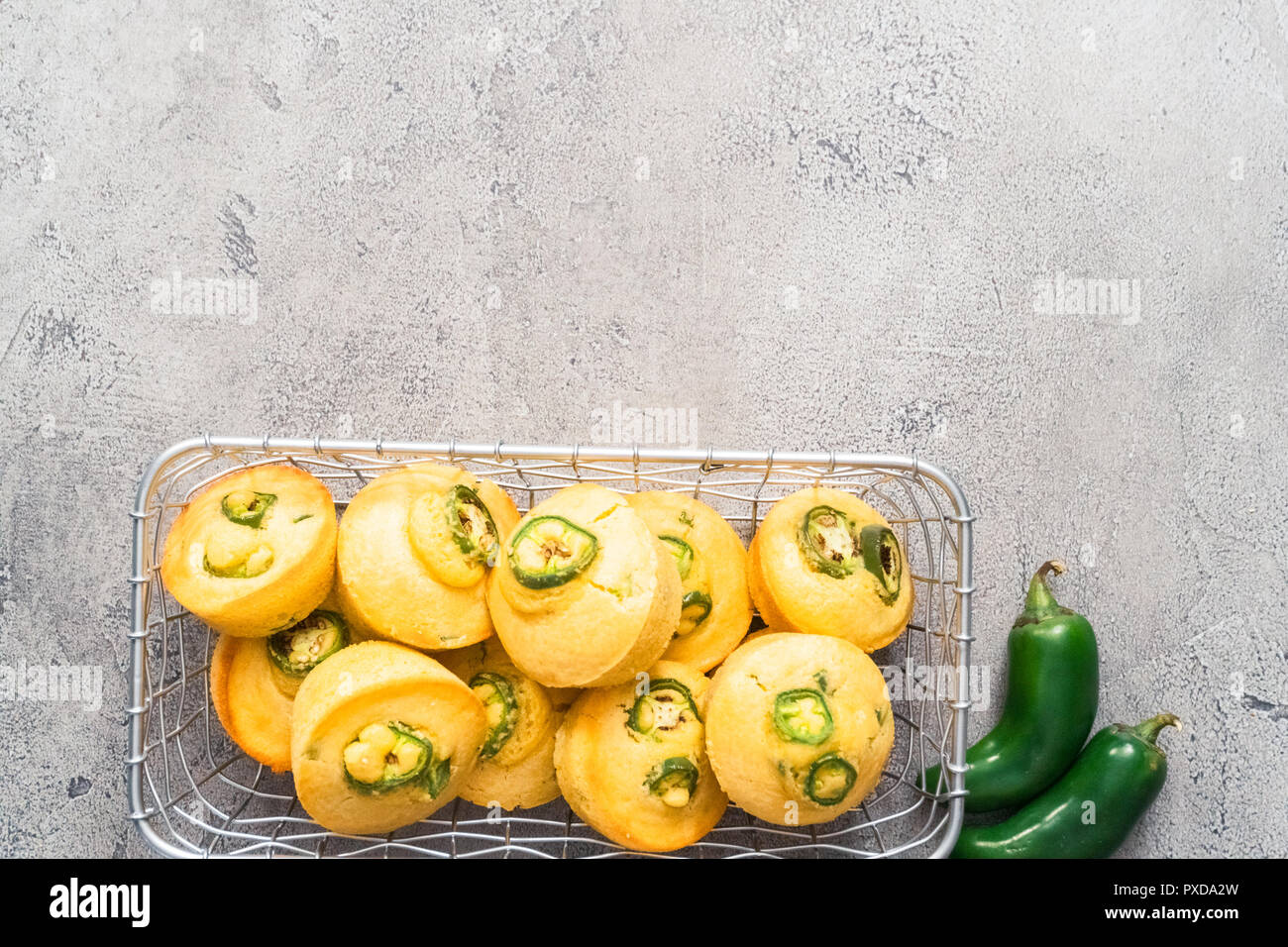 Flat lay. Freshly baked cornbread muffins with spicy jalapeno pepper in ...