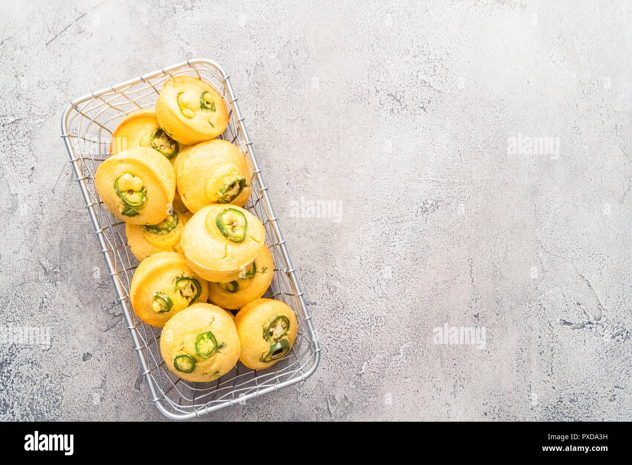 Flat lay. Freshly baked cornbread muffins with spicy jalapeno pepper in ...