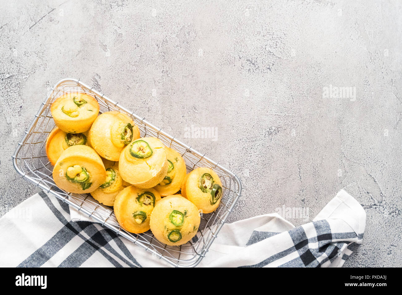 Flat lay. Freshly baked cornbread muffins with spicy jalapeno pepper in ...