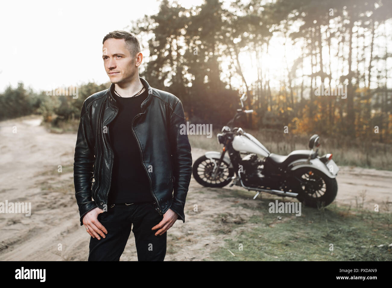 Handsome rider guy in black biker leather jacket on classic style cafe ...