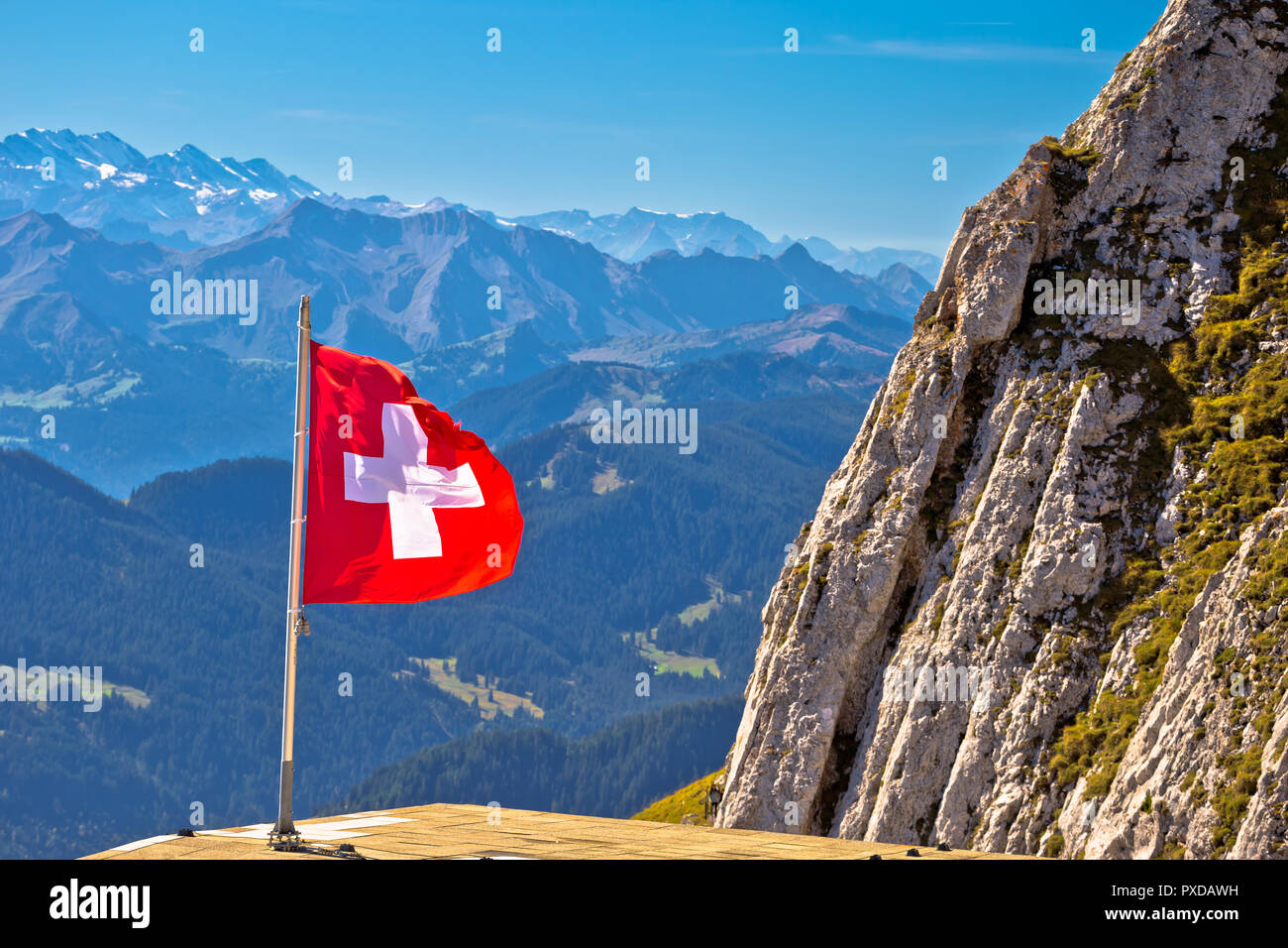 Swiss flag on Pilatus mountain with background alpine peaks, landscapes ...