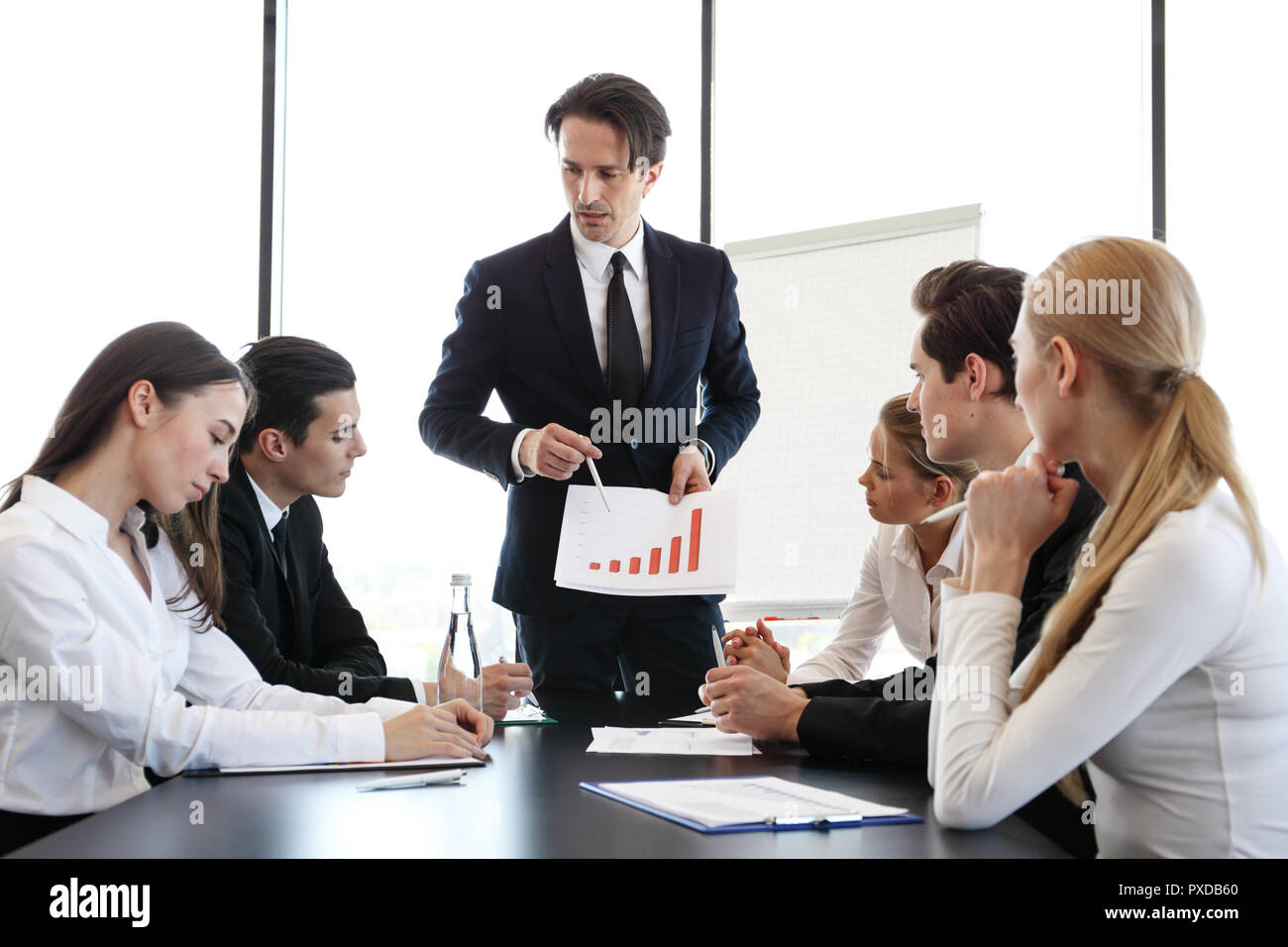 Business man showing financial statistics graph at meeting Stock Photo ...