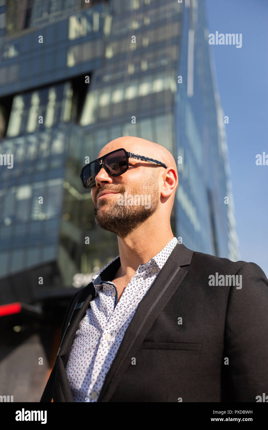 Handsome stylish bald manager using hi-res stock photography and images ...