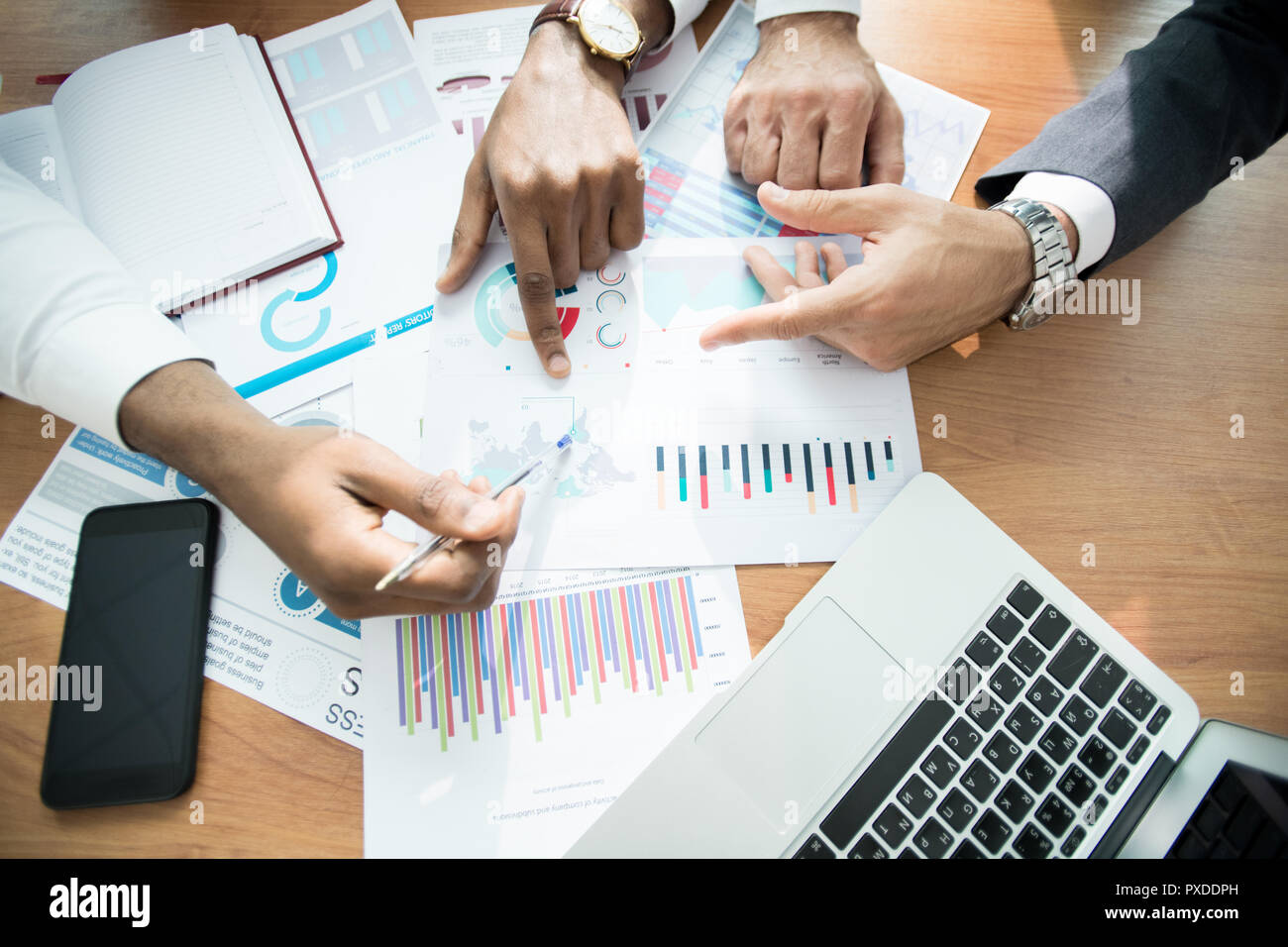 Business analysts discussing graphs at workplace Stock Photo - Alamy