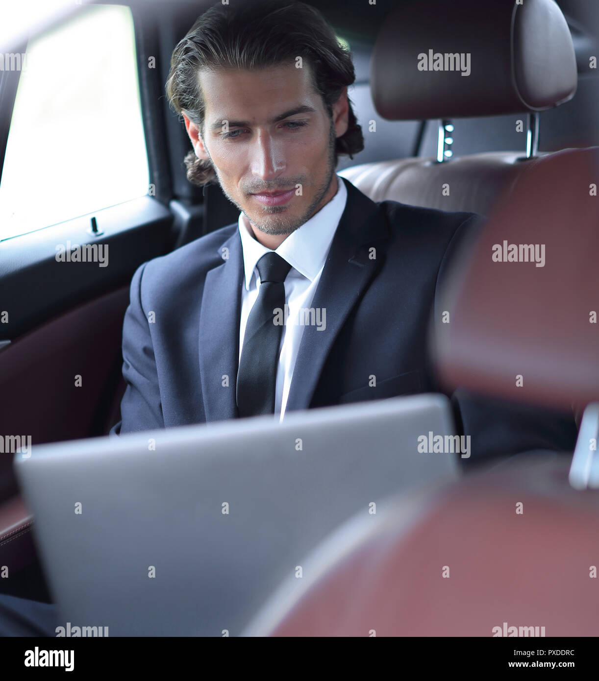 man working on laptop while sitting in the car Stock Photo - Alamy