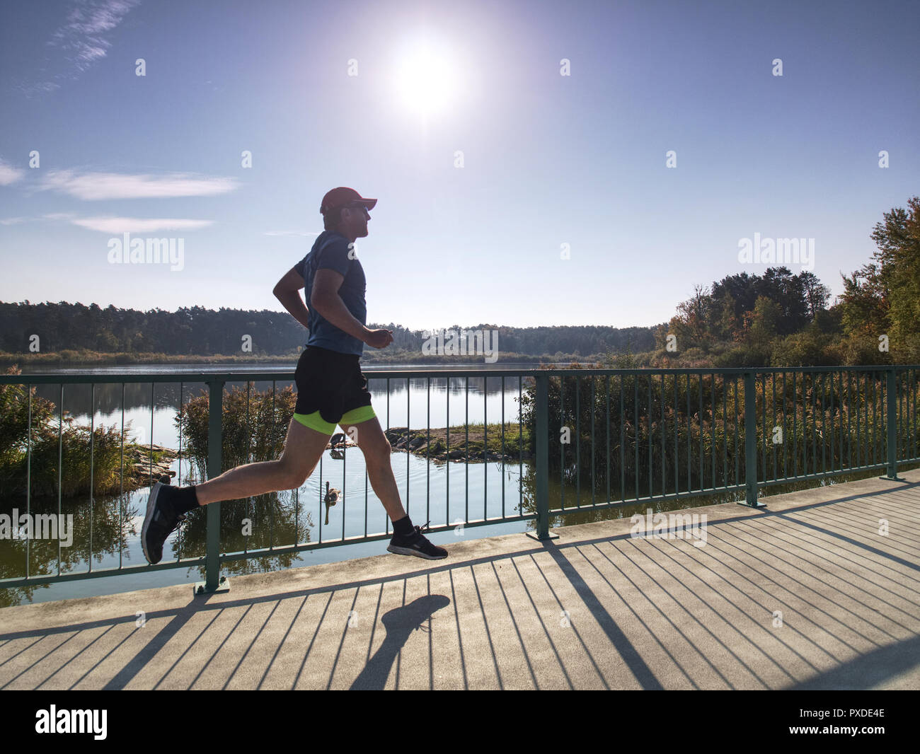 Running athlete man, side full body view. Male runner sprinting during ...