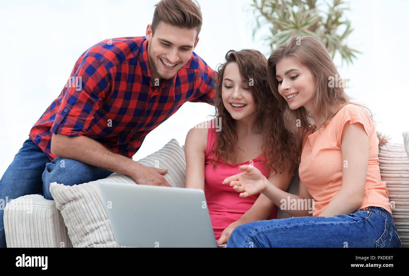 group of students sitting on the sofa in the living room Stock Photo ...
