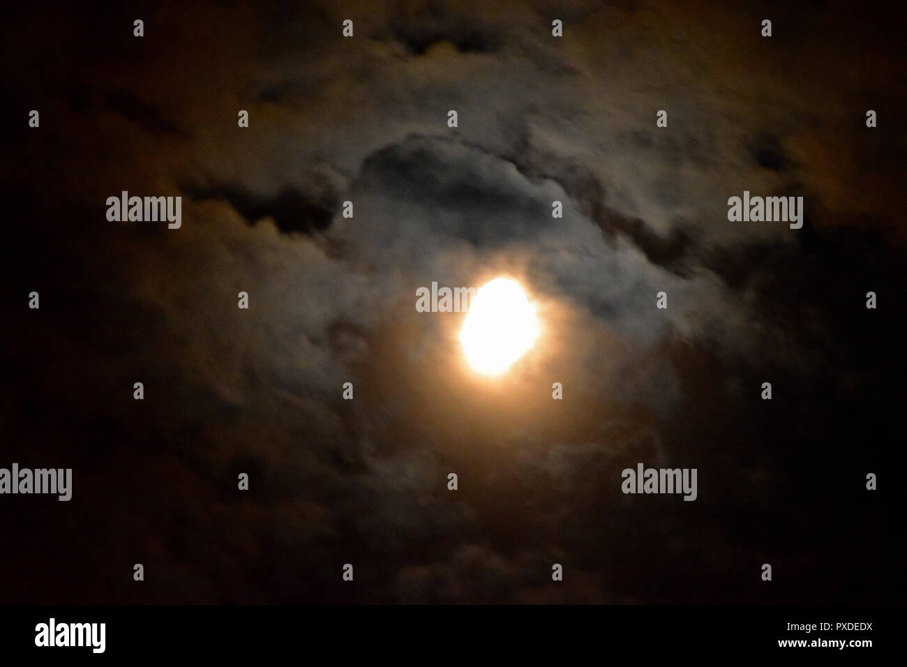 Moon behind the clouds High Resolution Stock Photography and Images - Alamy