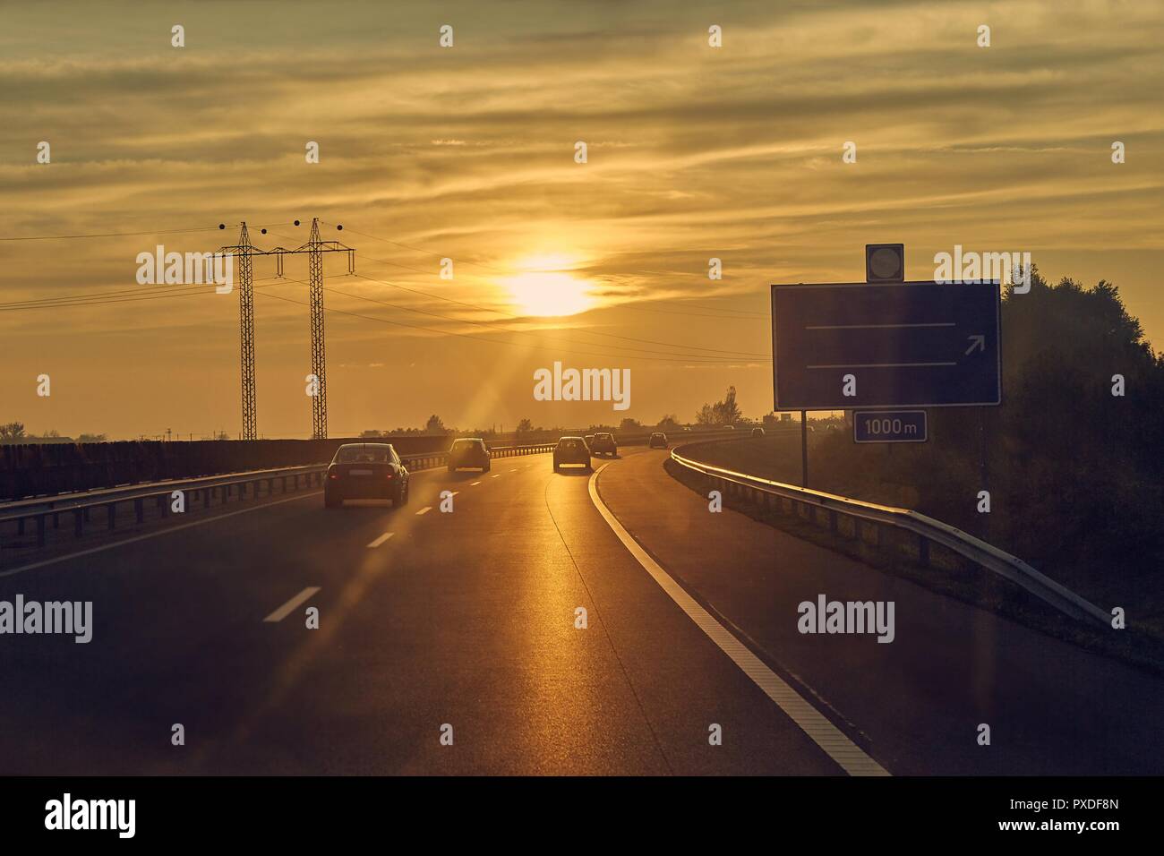 Driving in sunset Stock Photo - Alamy