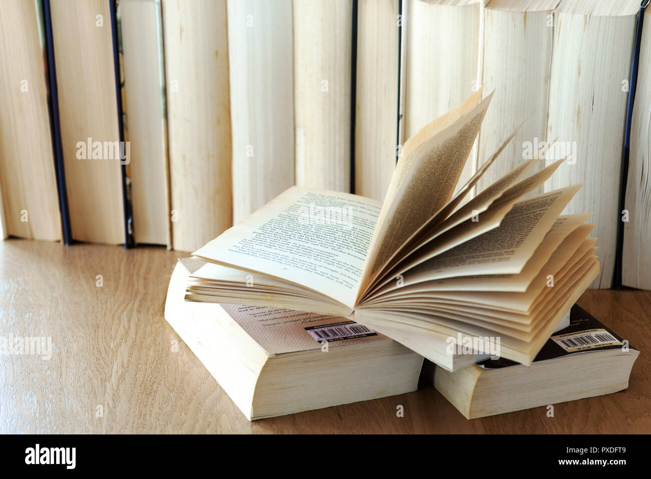 Row of old books open book at the front Stock Photo - Alamy