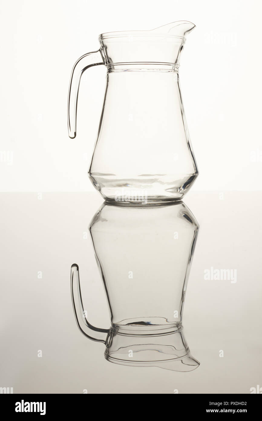 Empty glass pitcher on white Stock Photo - Alamy