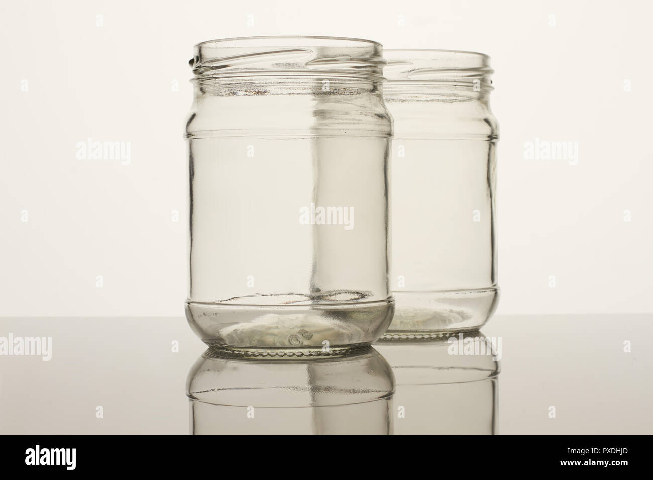 Two glass transparent empty jars Stock Photo - Alamy
