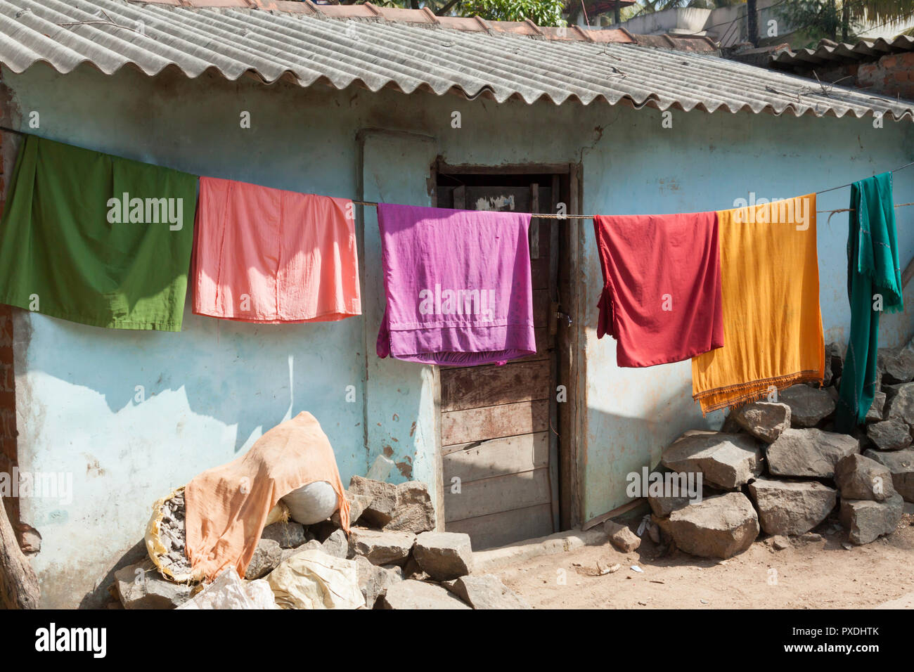 Colourful washing hanging on a line outside a house in Thekkay, Kerala ...