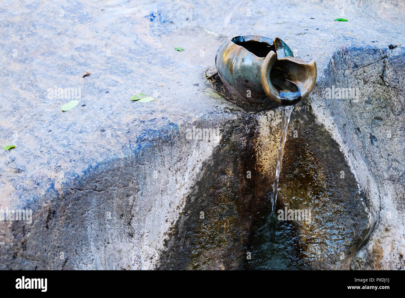clay jug,water is drop from clay jug in the garden Stock Photo - Alamy