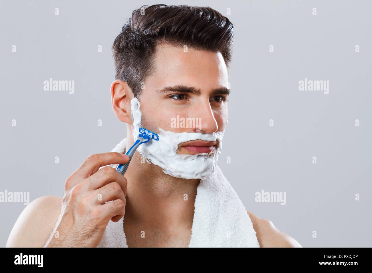 Handsome man shaving his beard Stock Photo - Alamy