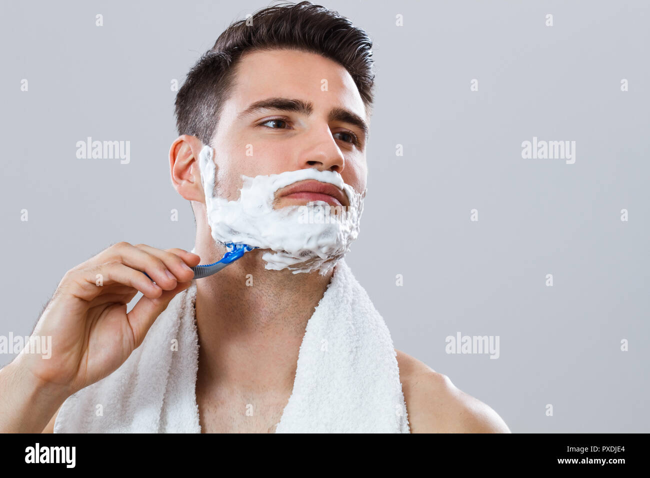 Handsome man shaving his beard Stock Photo - Alamy