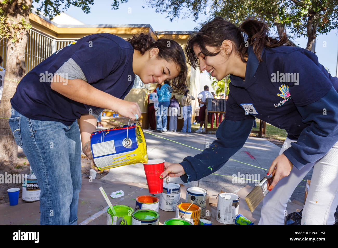 Helping student students paint mural hi-res stock photography and ...