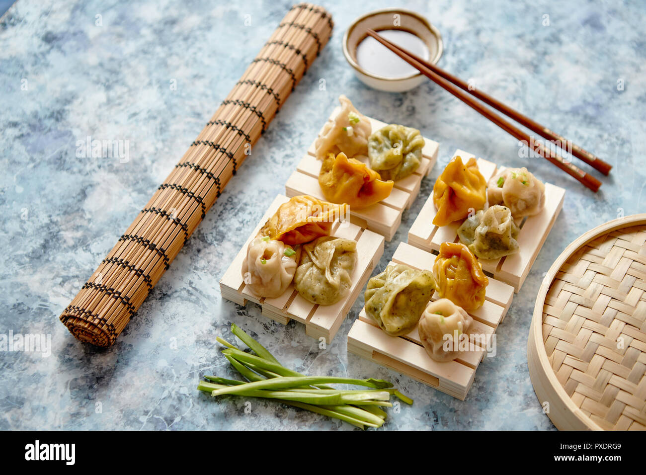 Delicious mixed kinds of chinese dumplings served on wooden stands ...