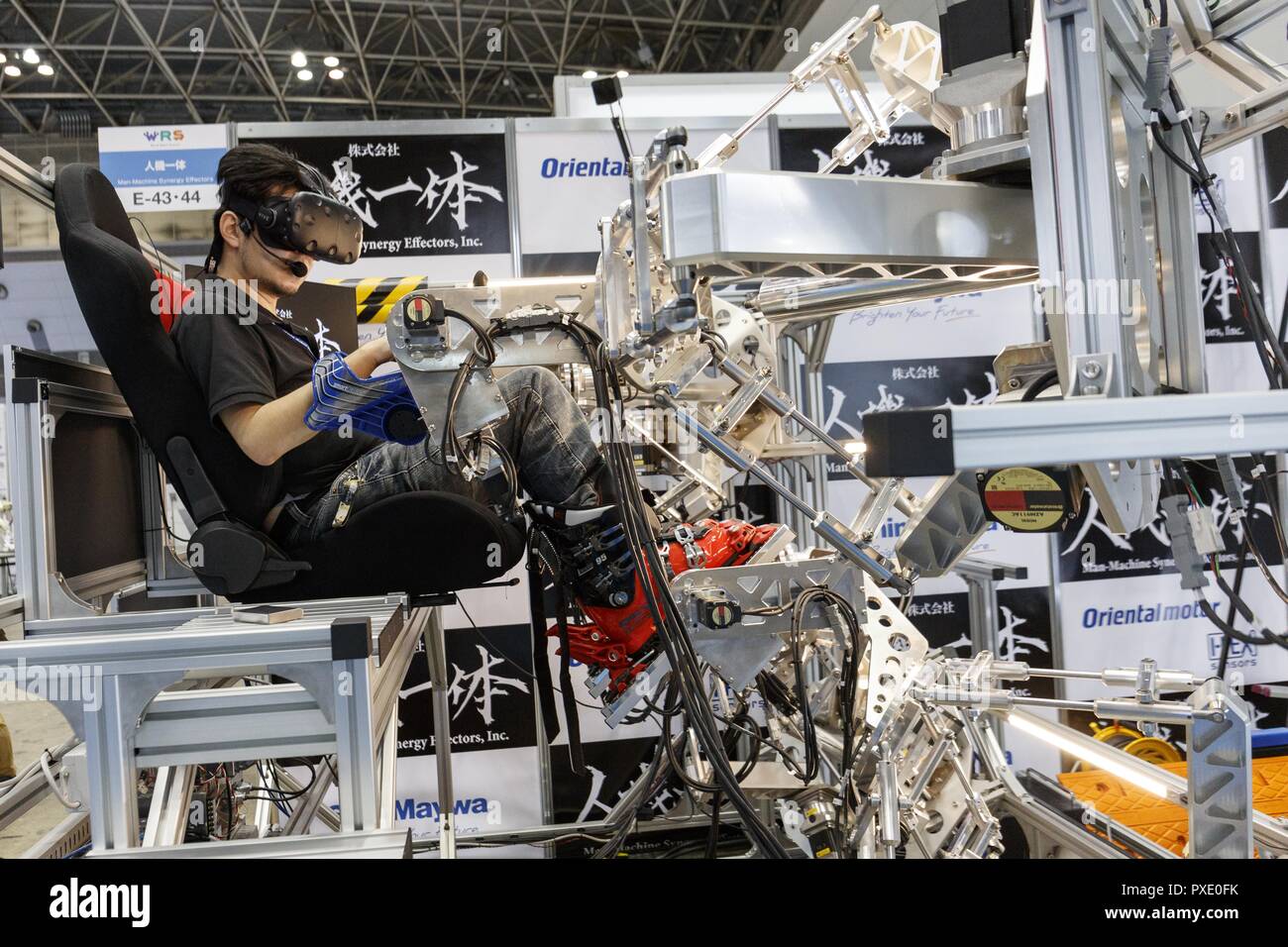 Tokyo, Japan. 21st Oct, 2018. A man controls a long distance a robot ...