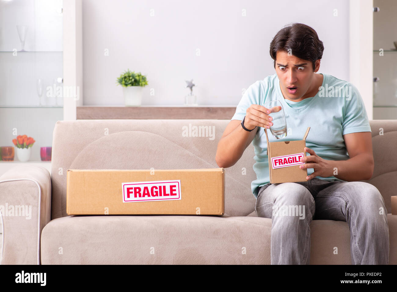 Man opening fragile parcel ordered from internet Stock Photo - Alamy