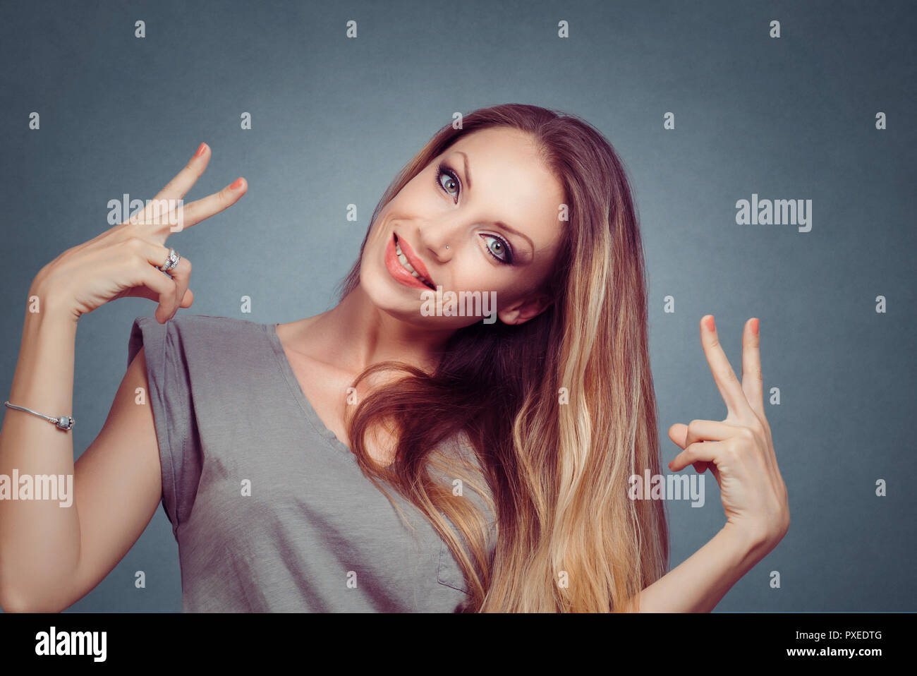 Young beautiful smiling girl woman showing peace gesture. Isolated on ...
