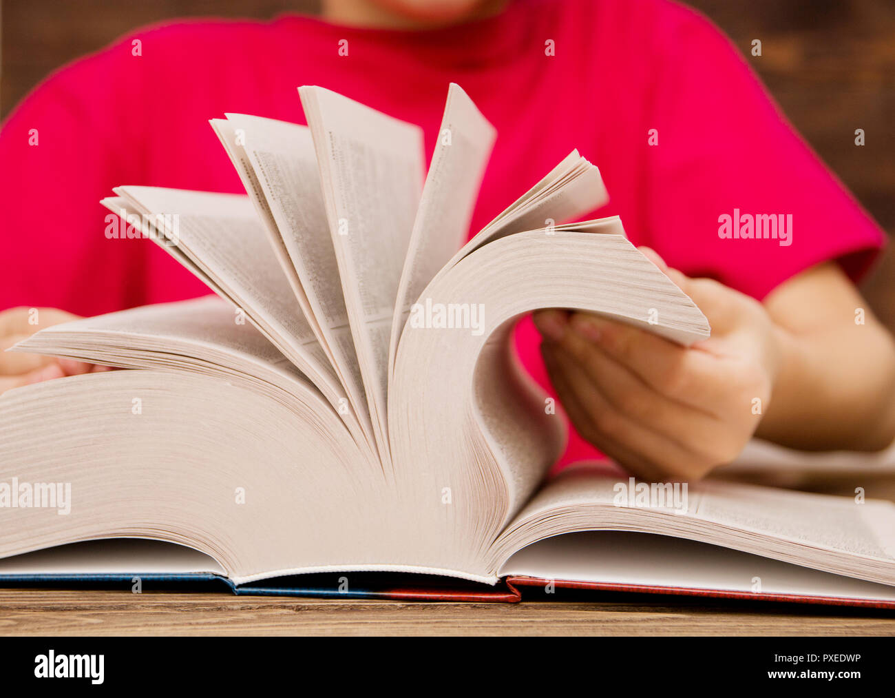 Close-up of the hand on the book is going to turn the page to the next ...