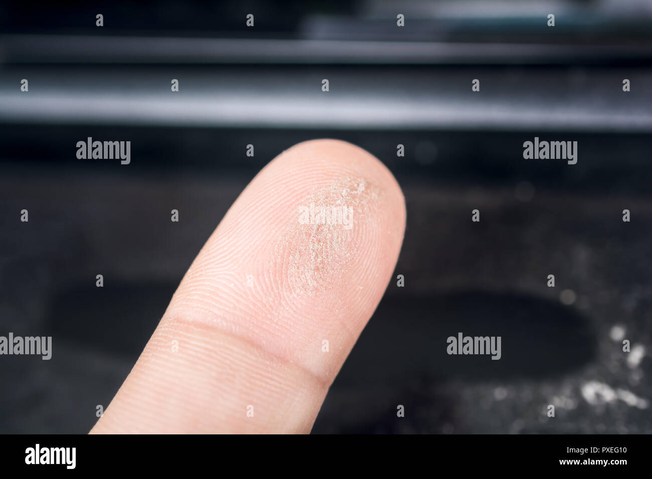 Macro Of A Finger Streaked Through Dust On A Black Surface Stock Photo ...