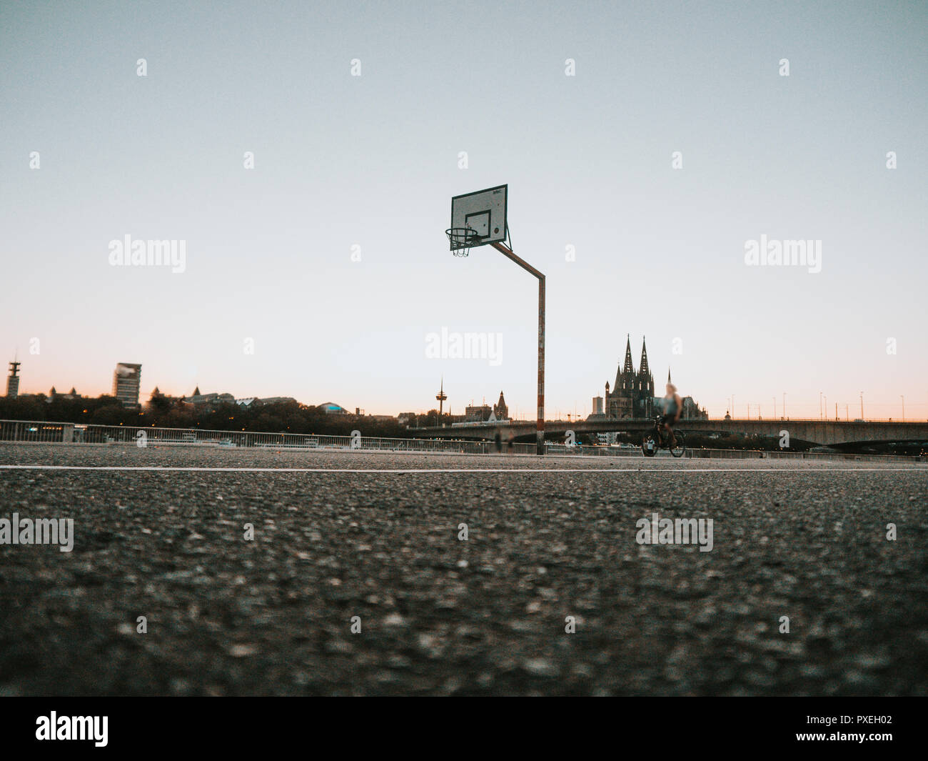 Urban Basketball hoop at sunset with skyline of Cologne, Germany, in ...