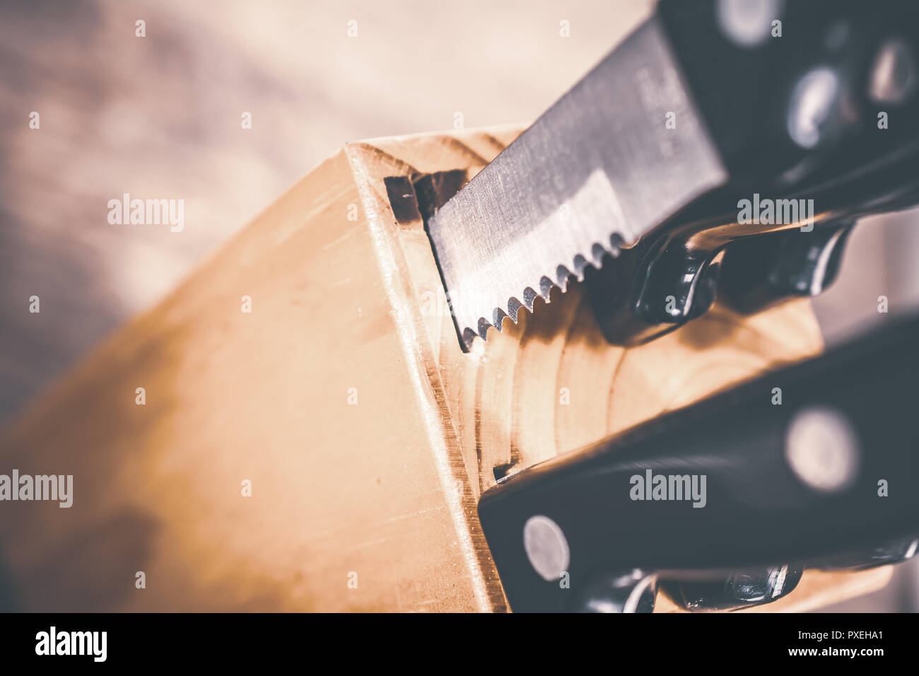 Macro Of A Jagged Steak Knife Half Pulled Out Of A Kitchen Knive Block ...